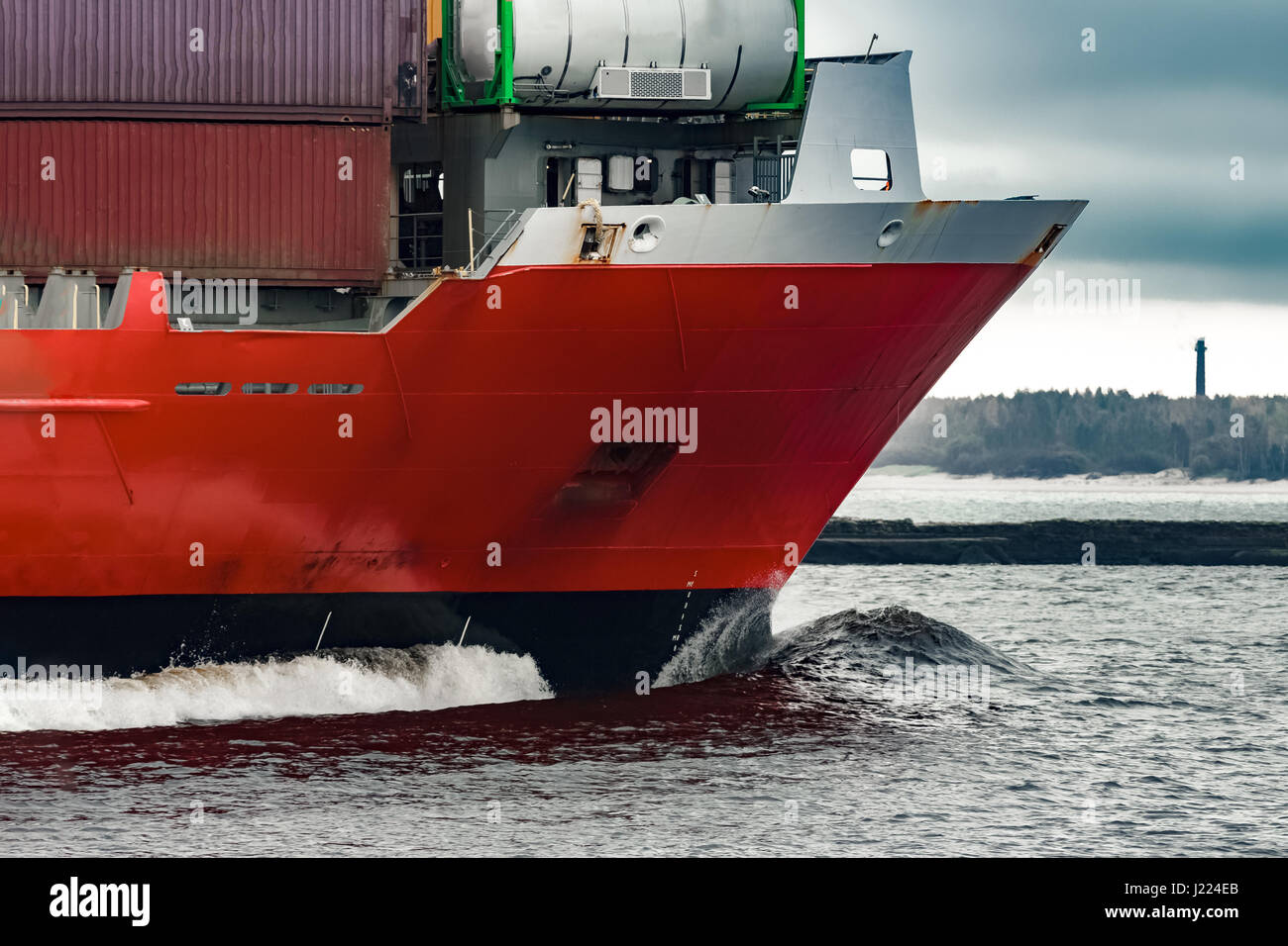 Red cargo container ship's bow in cloudy day Stock Photo - Alamy