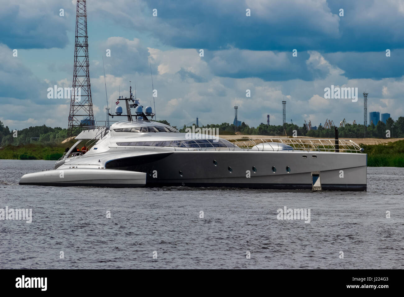 Large silver trimaran. Luxury yacht sailing by the river in Riga Stock ...