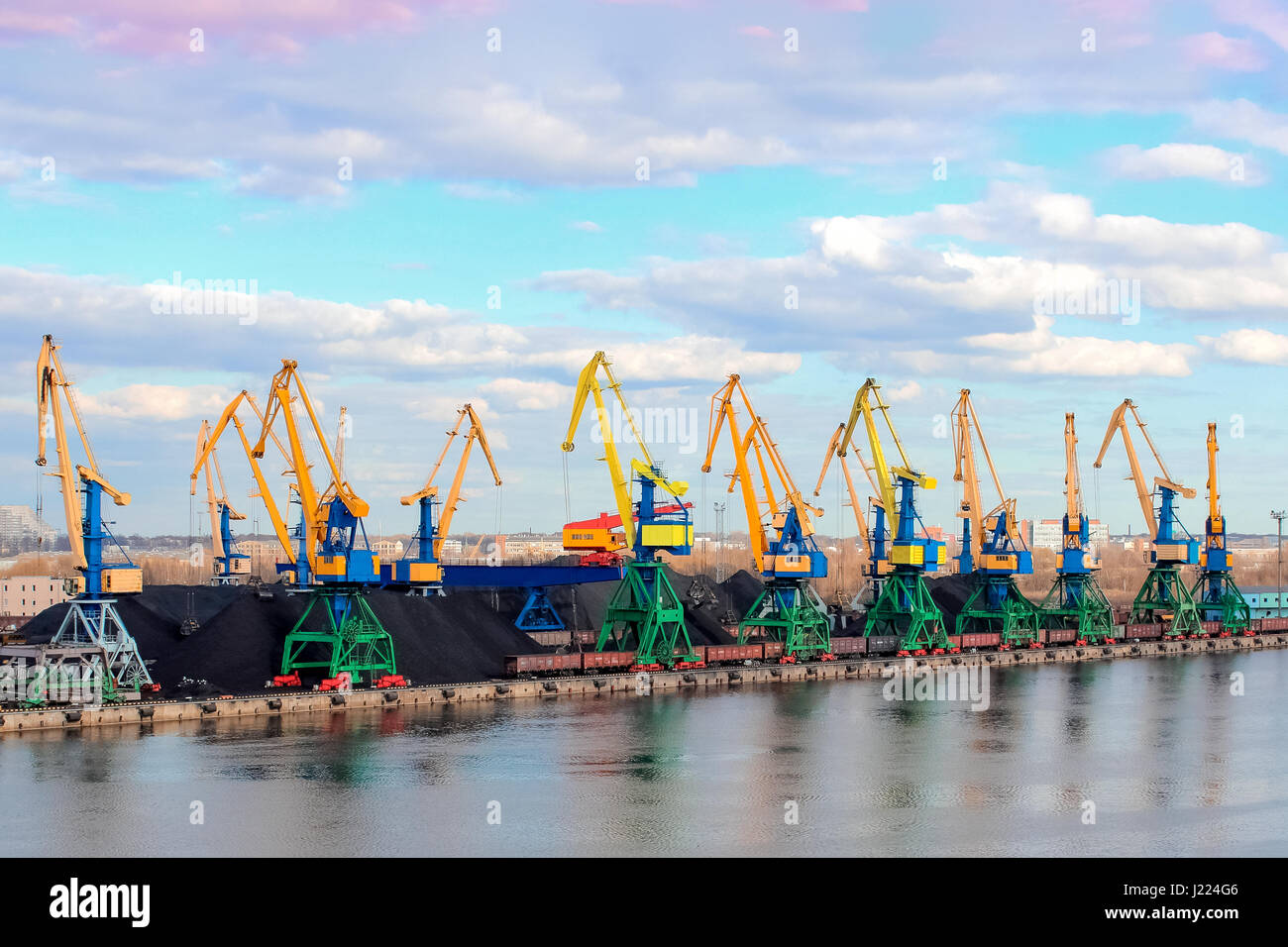 Baltic coal terminal with port cranes near the river. Riga cargo Stock ...