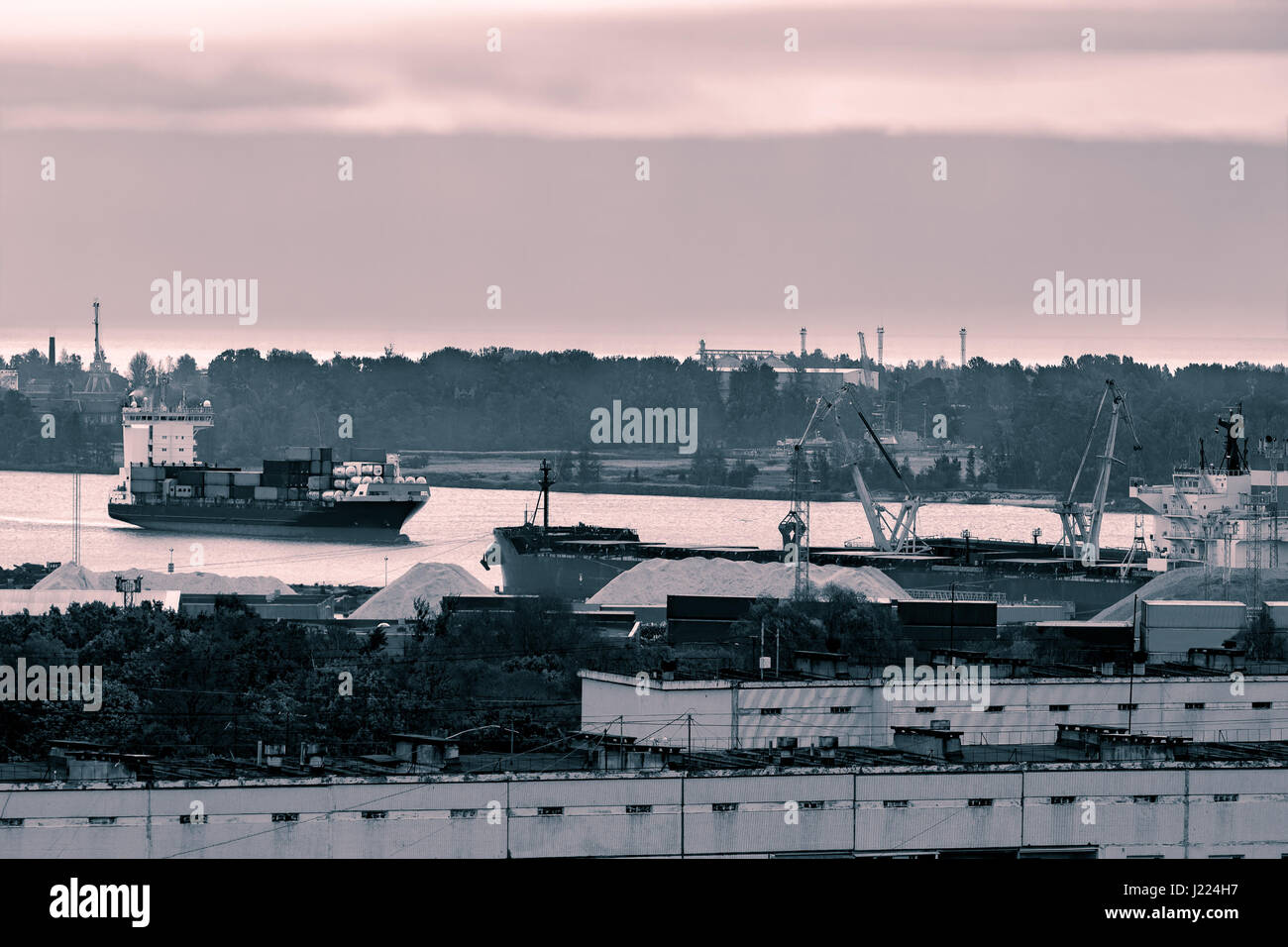 Red container ship entering port of Riga, Latvia Stock Photo - Alamy