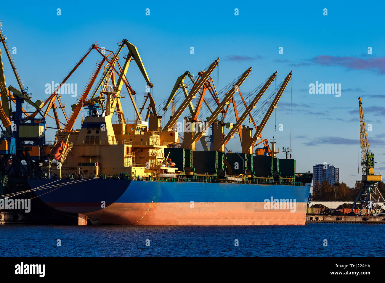 Blue cargo ship loading in the port of Riga, Europe Stock Photo - Alamy
