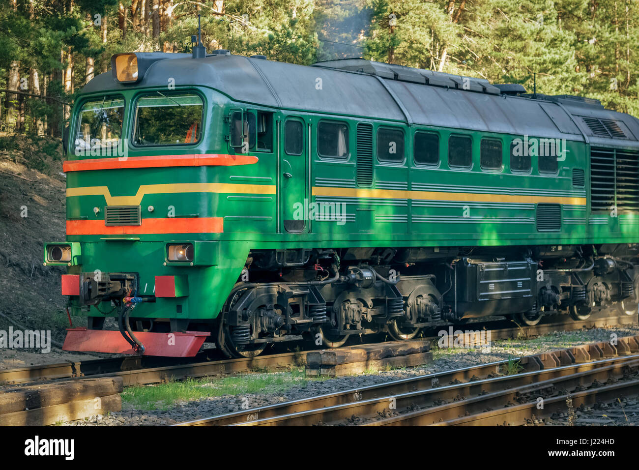Green diesel cargo locomotive in forest Stock Photo - Alamy