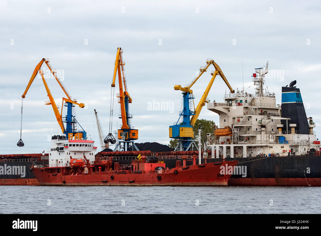 Red cargo ship loading in the port of Riga, Europe Stock Photo - Alamy