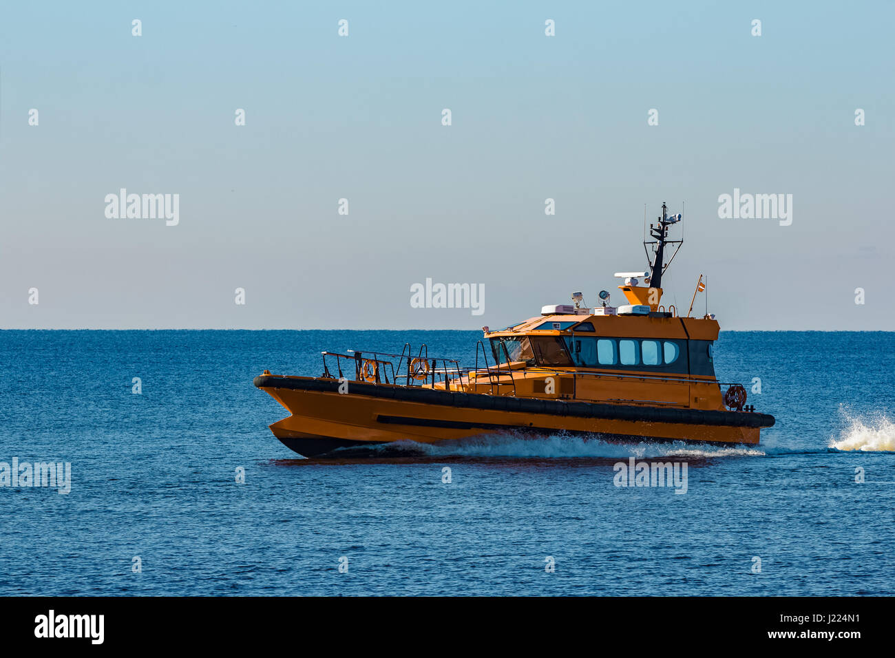 Yellow pilot ship moving at speed from the Baltic sea Stock Photo - Alamy