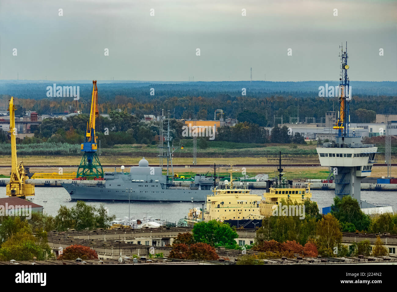 Military ship sailing past the cargo port in Riga, Latvia Stock Photo ...
