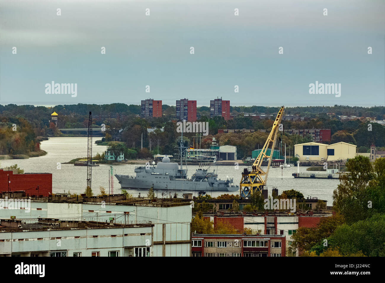 Military ship sailing past the cargo port in Riga, Latvia Stock Photo ...