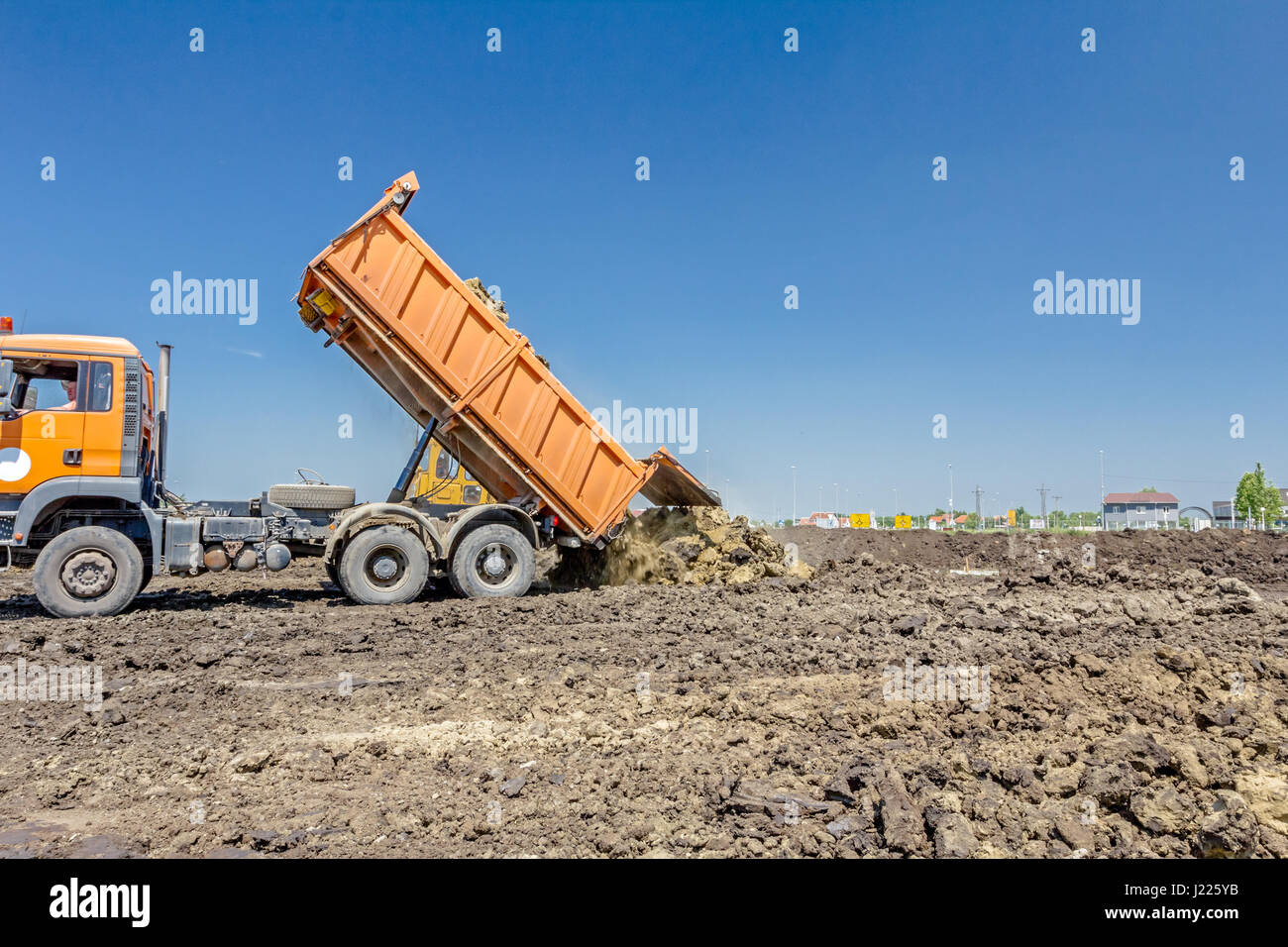 Heavy wheels are working at construction site Stock Photo - Alamy