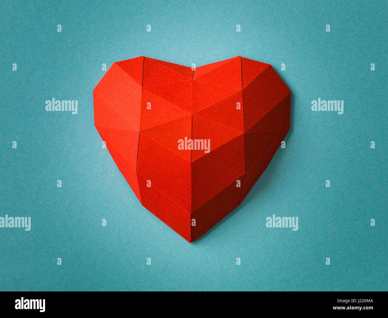 red heart on blue ice papercraft concept Stock Photo - Alamy