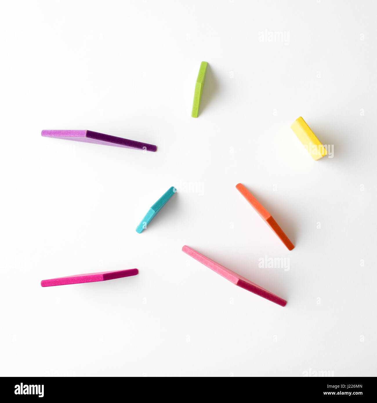 Upper view of color geometric shapes with shadows on white background ...