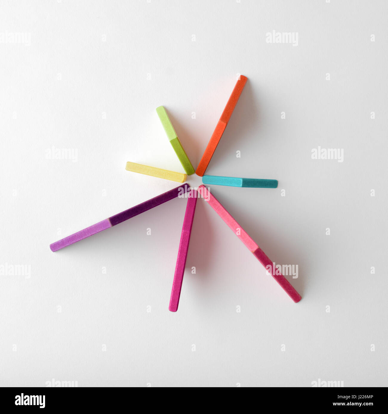 Upper view of color geometric shapes with shadows on white background ...