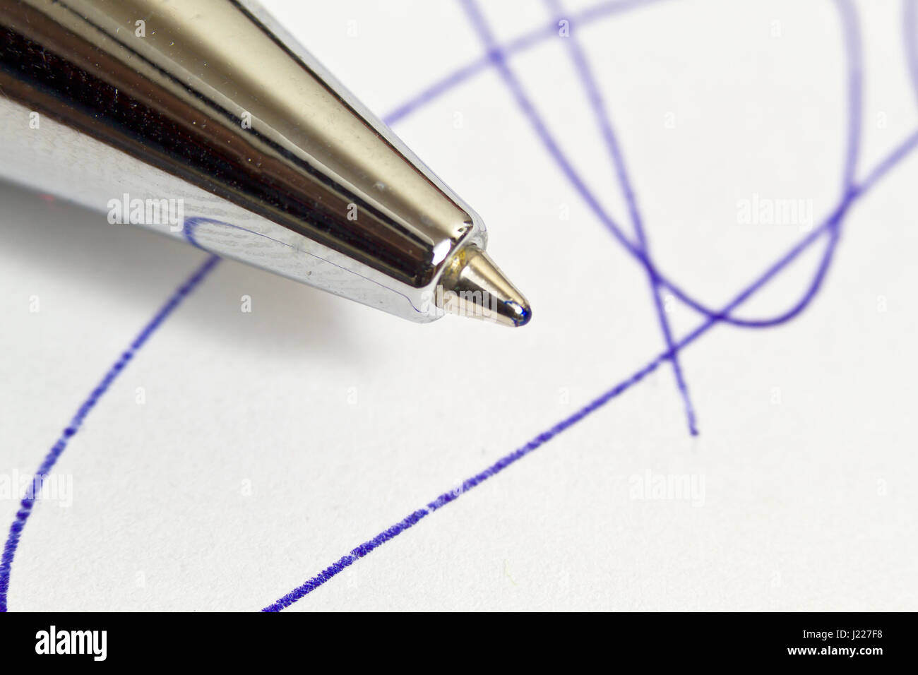 signing with pen on a white background Stock Photo - Alamy