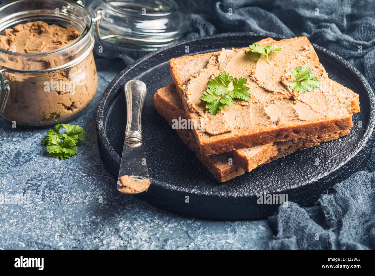 Fresh homemade chicken liver pate on bread over rustic background Stock ...