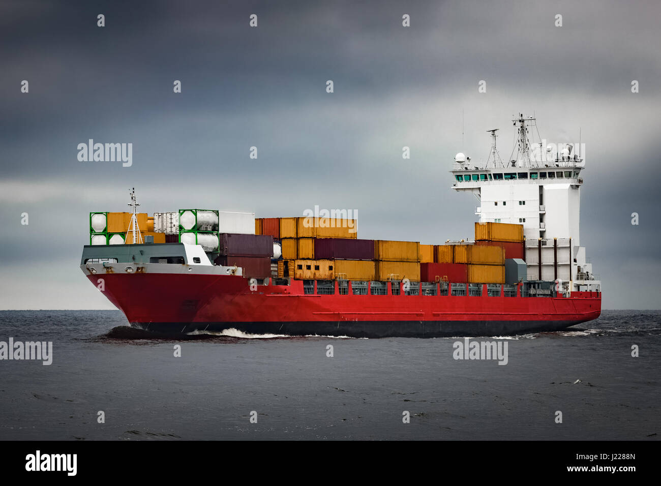Red cargo container ship sailing from Baltic sea in cloudy day Stock ...