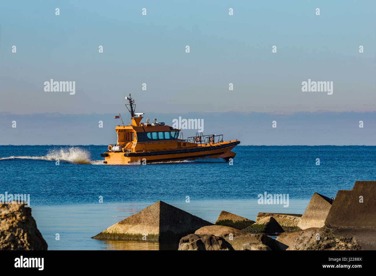 Yellow pilot ship moving at speed from the Baltic sea Stock Photo - Alamy