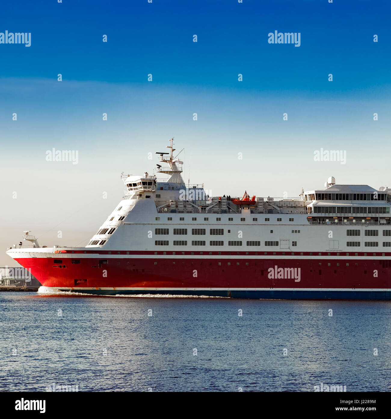 Red cruise liner. Passenger ferry ship sailing in still water Stock ...