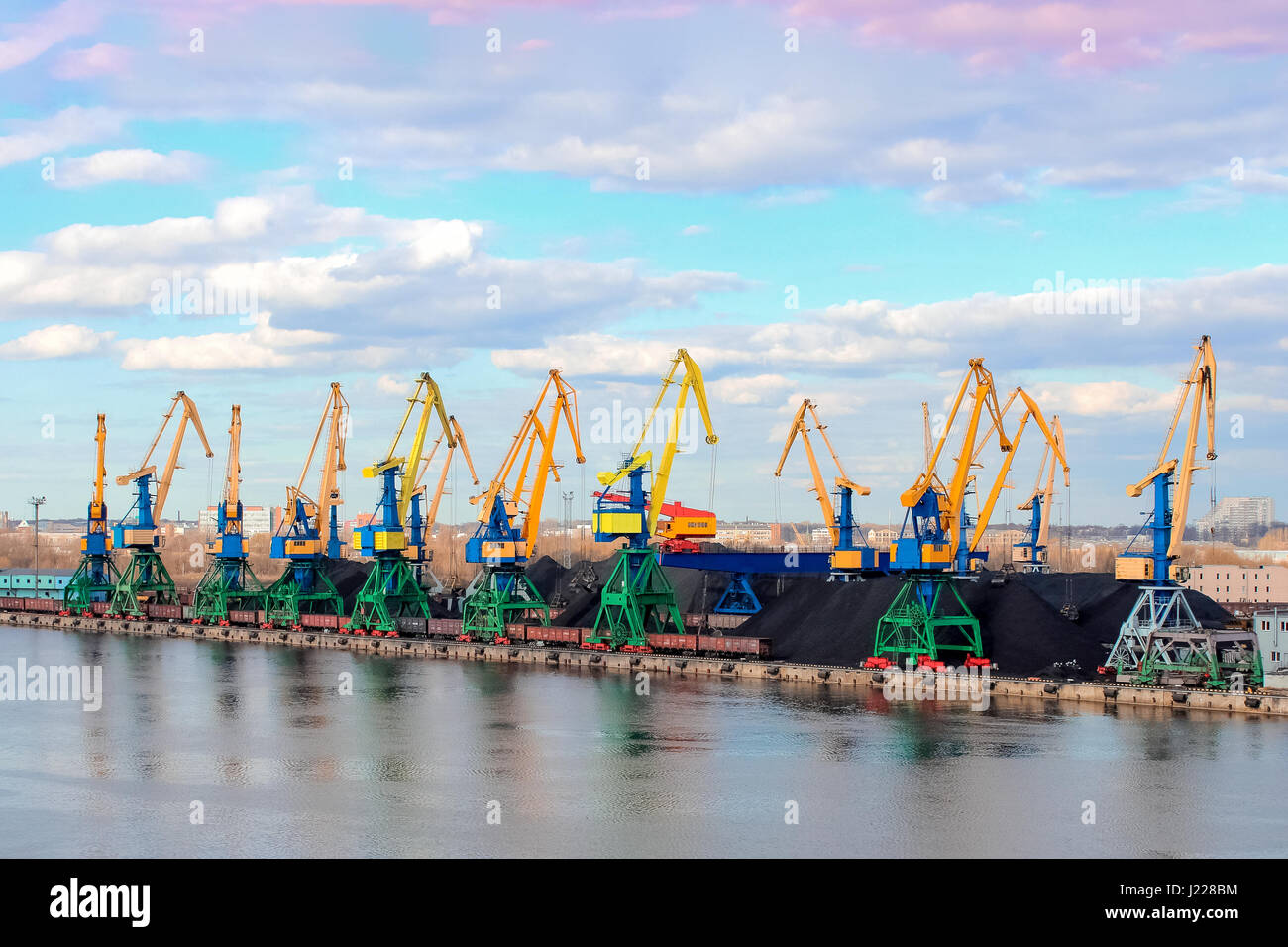 Baltic coal terminal with port cranes near the river. Riga cargo Stock ...