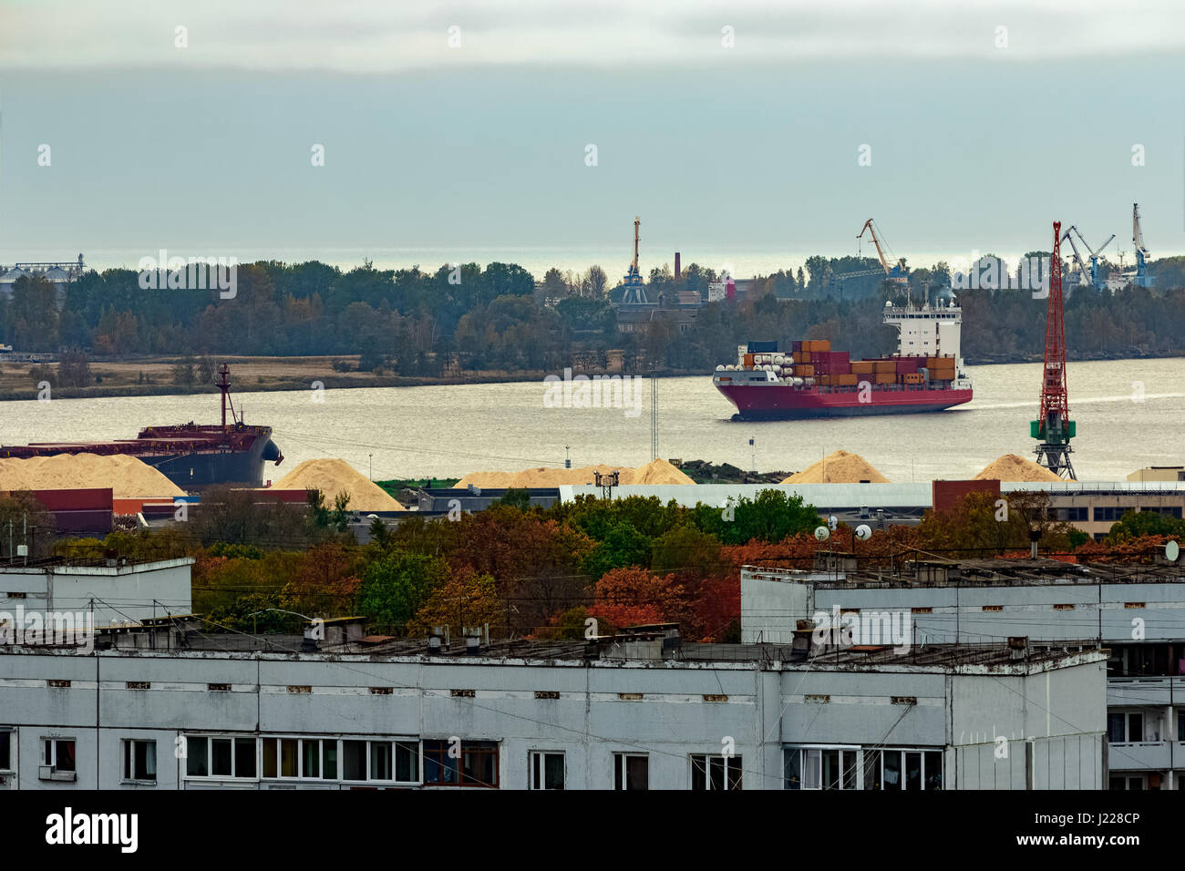 Red container ship entering port of Riga, Latvia Stock Photo - Alamy