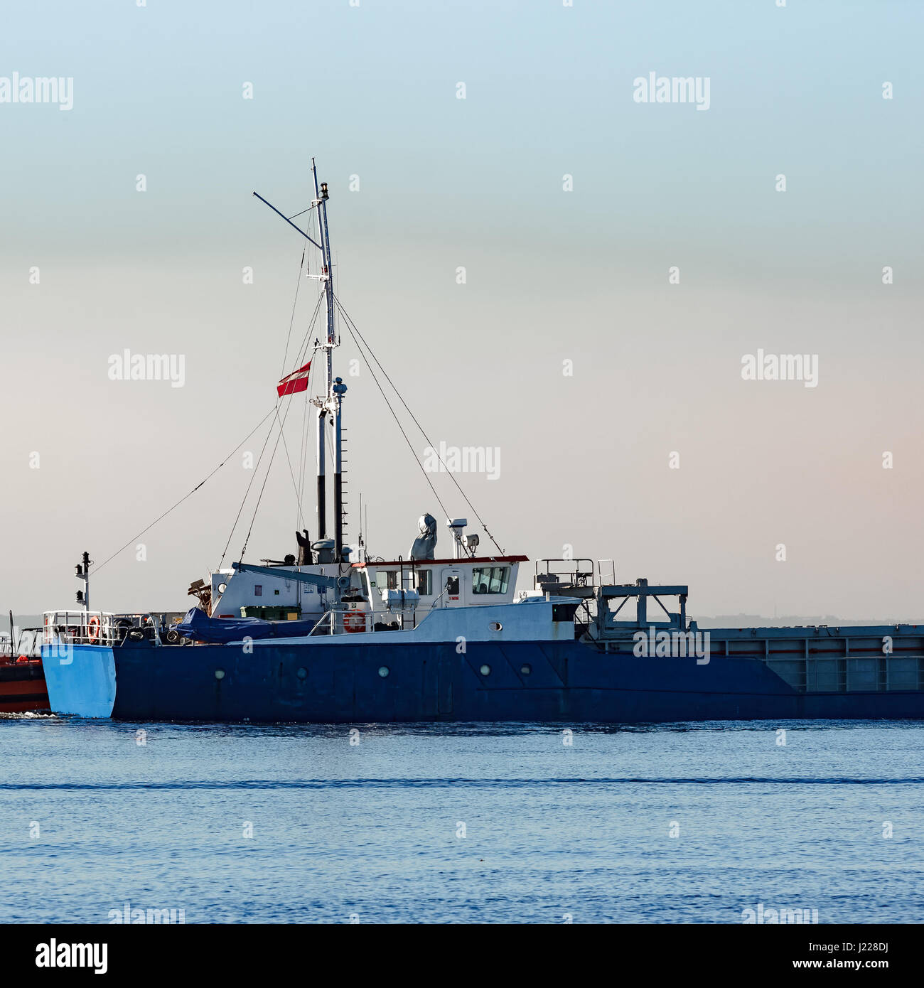 Blue cargo ship leaving Riga and entering Baltic sea Stock Photo - Alamy