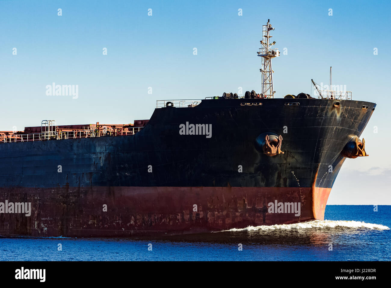 Black cargo ship's bow in still water. Riga, Europe Stock Photo - Alamy