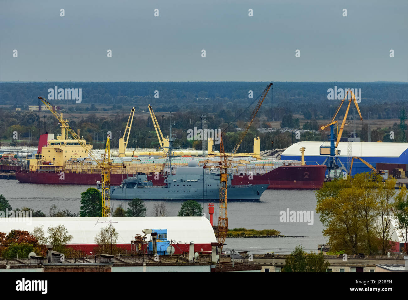 Military ship sailing past the cargo port in Riga, Latvia Stock Photo ...