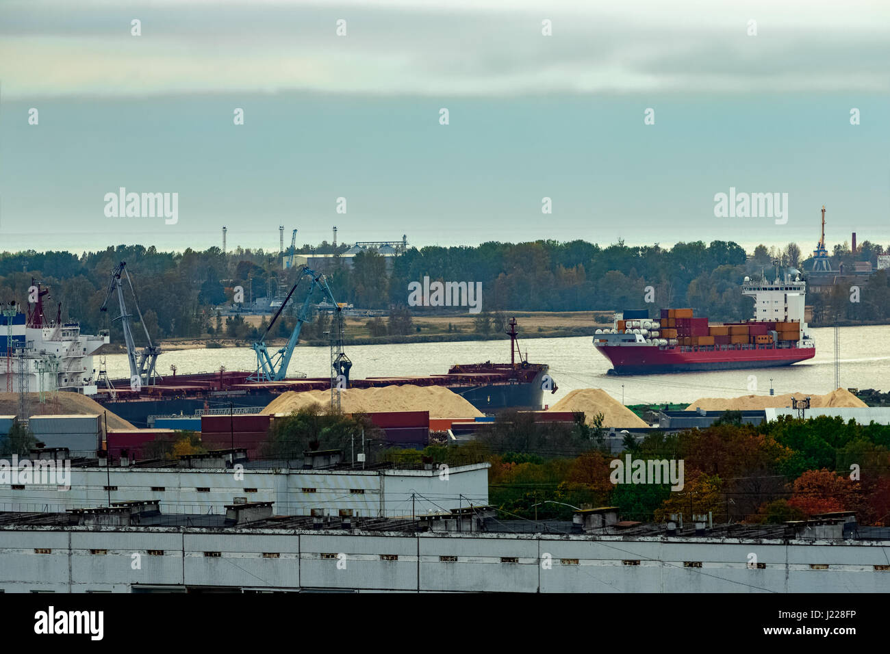 Red container ship entering port of Riga, Latvia Stock Photo - Alamy