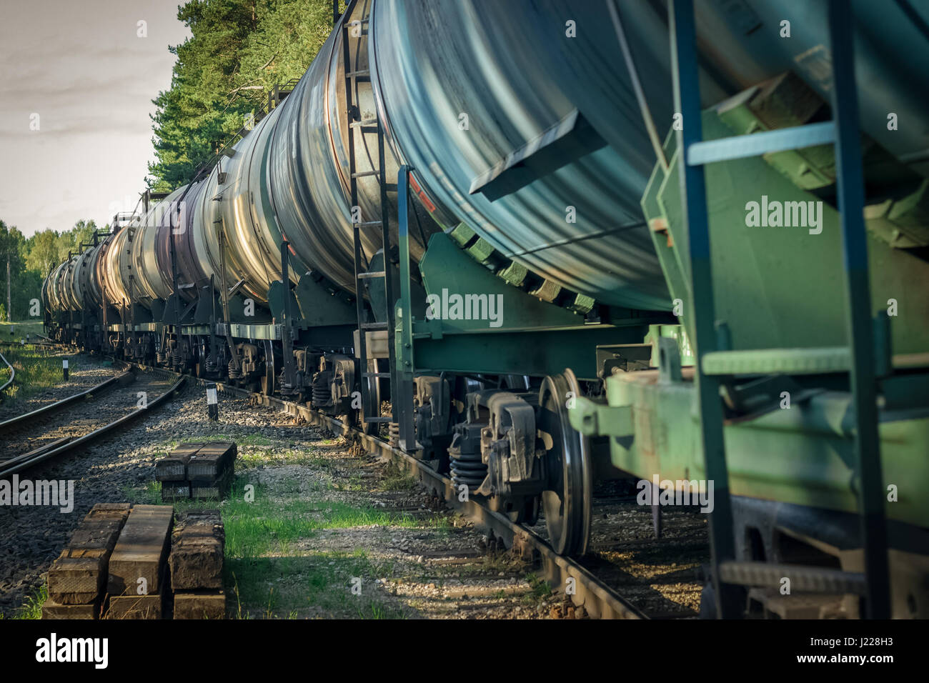 Tank wagons with oil. Freight train in forest Stock Photo - Alamy