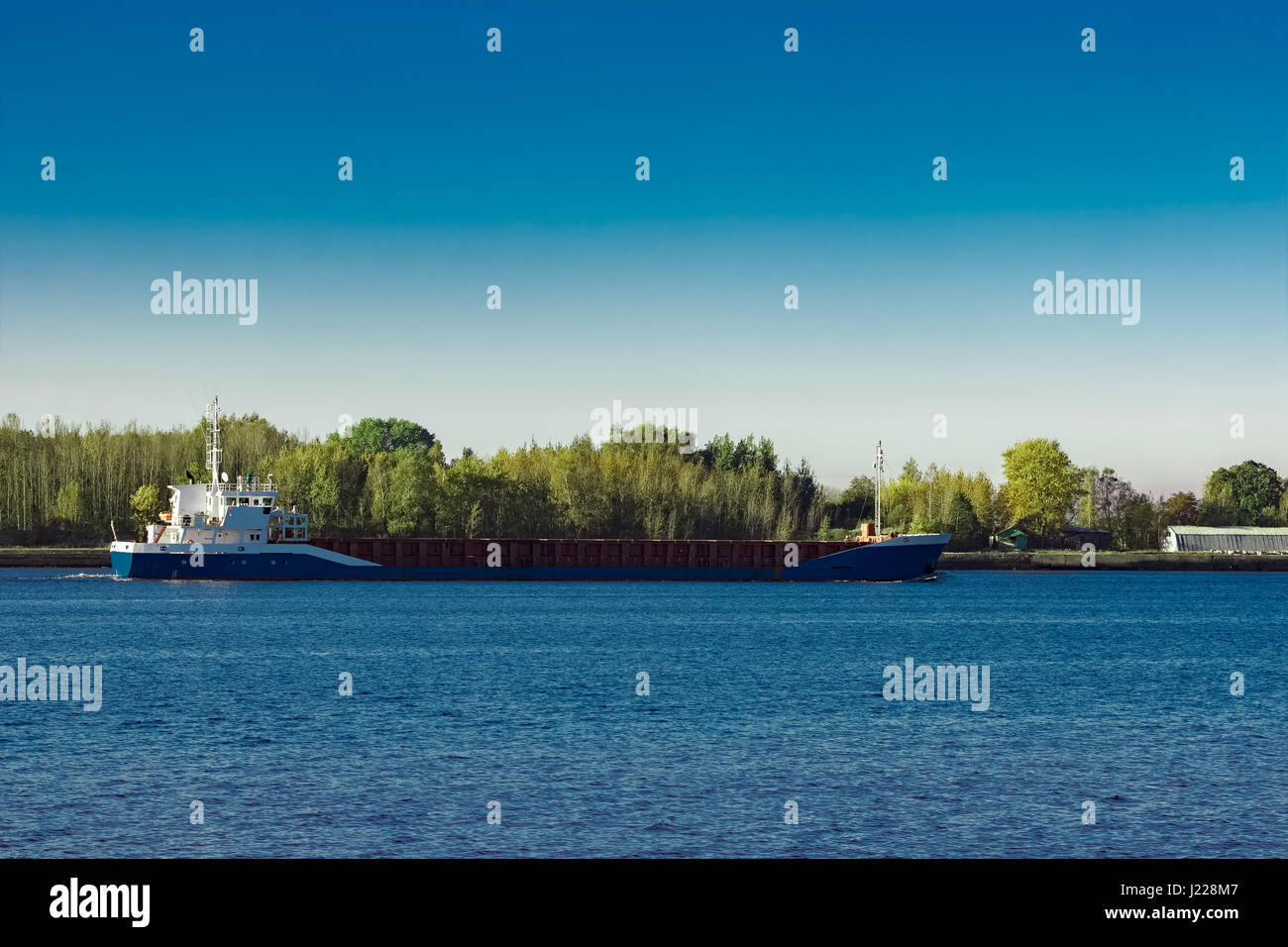 Blue cargo ship leaving Riga and entering Baltic sea Stock Photo - Alamy