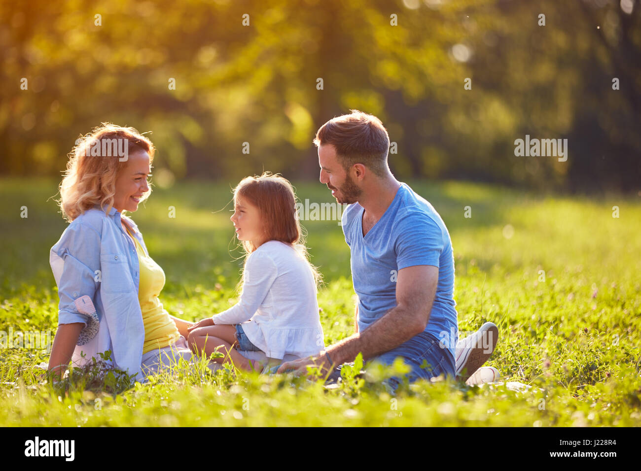 Happy family together in green nature Stock Photo - Alamy