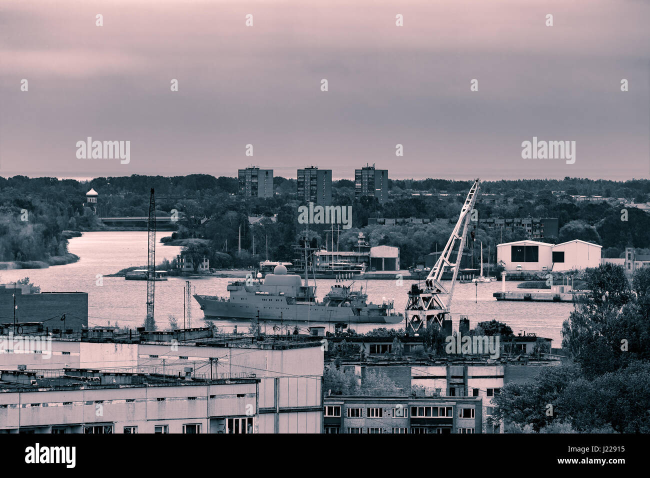 Military ship sailing past the cargo port in Riga, Latvia Stock Photo ...