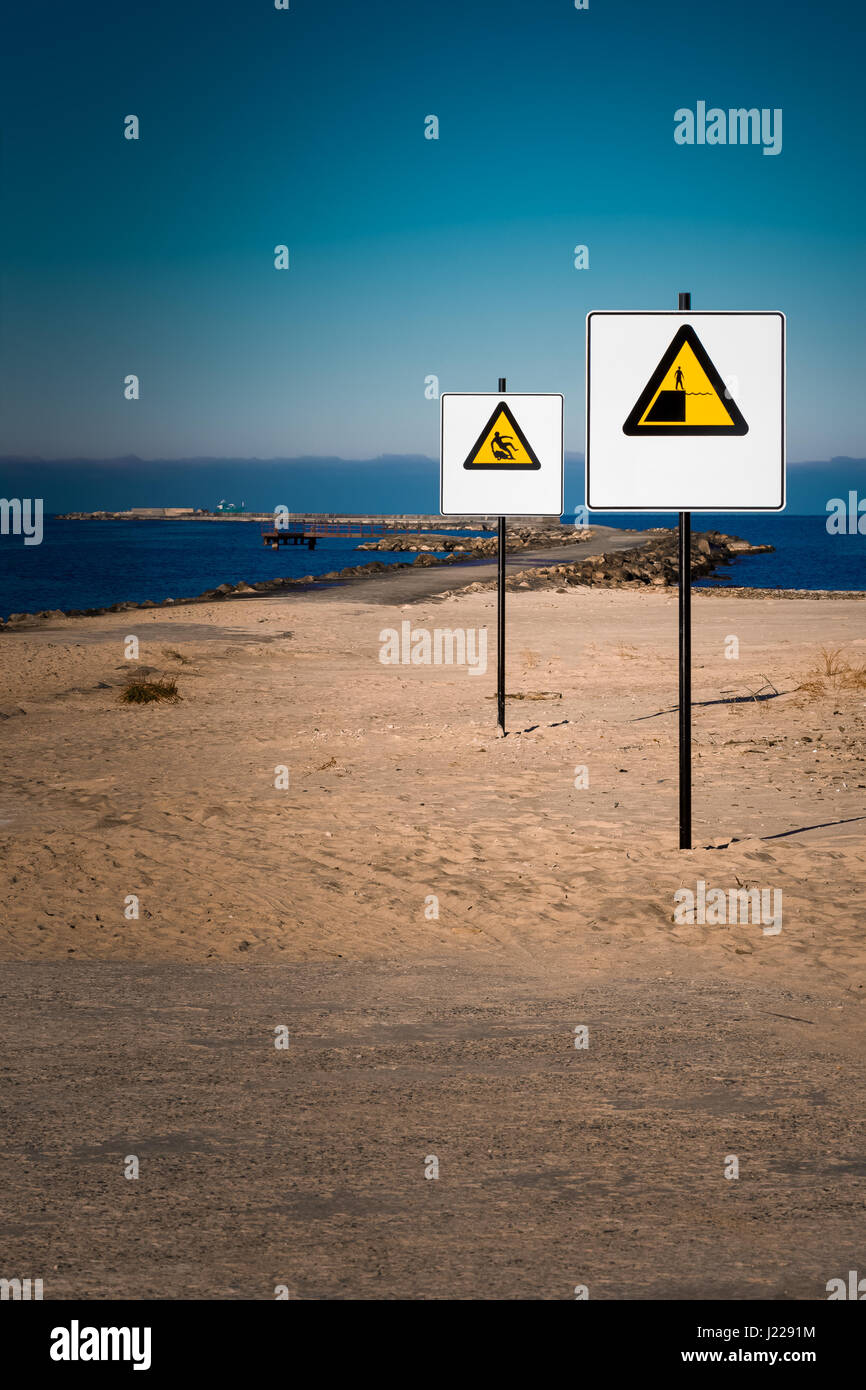 Yellow warning signs on summer beach, Riga Stock Photo - Alamy
