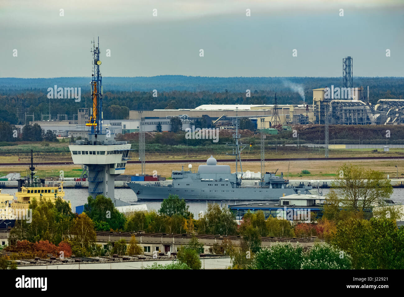 Military ship sailing past the cargo port in Riga, Latvia Stock Photo ...