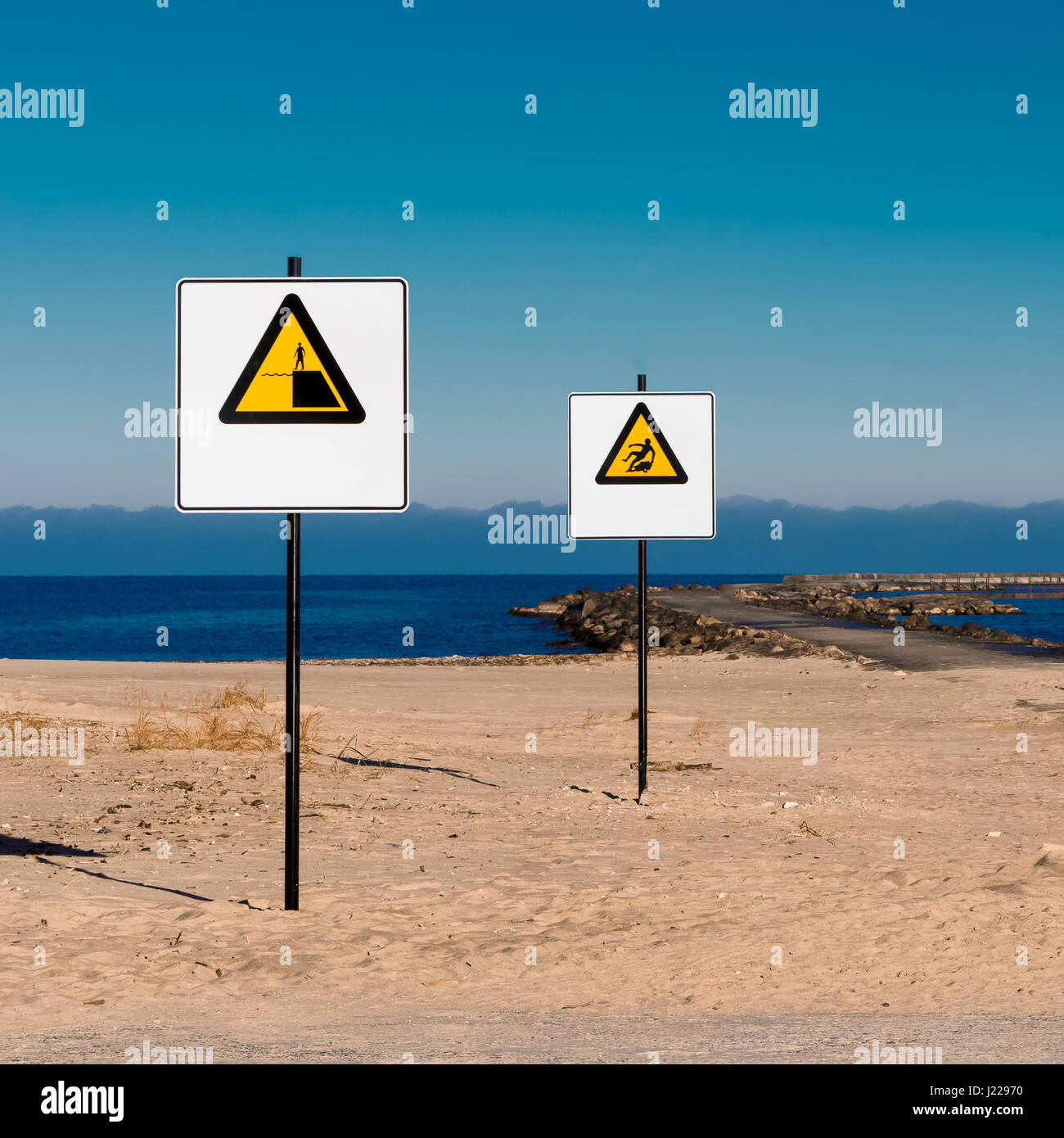 Yellow warning signs on summer beach, Riga Stock Photo - Alamy