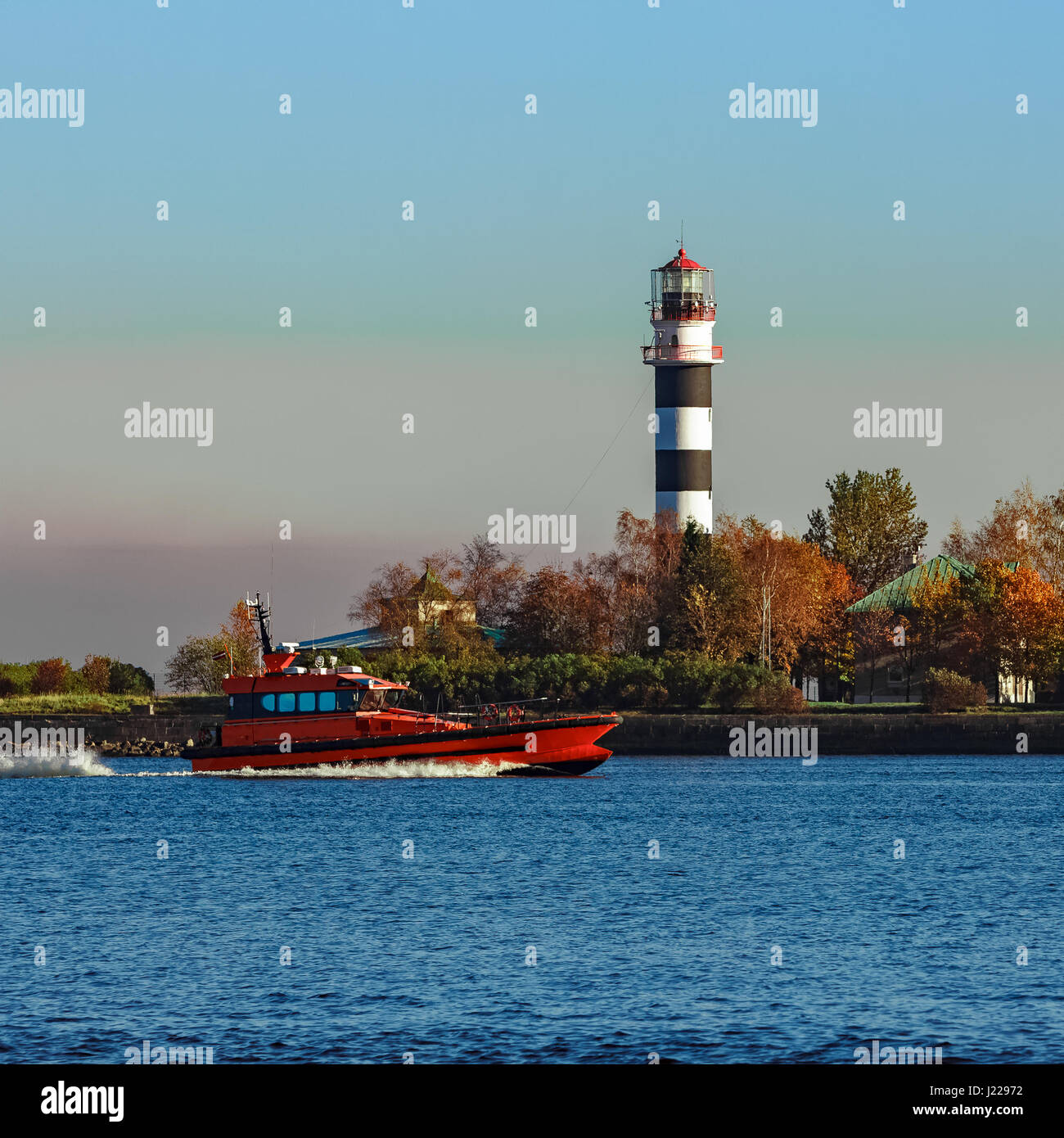Red pilot ship moving past the lighthouse in Riga Stock Photo - Alamy