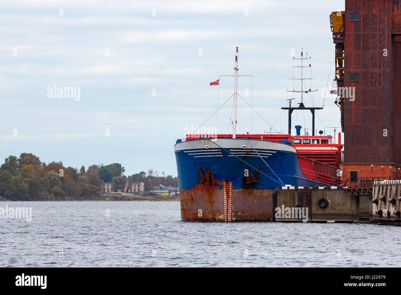 Blue cargo ship loading in the port of Riga, Europe Stock Photo - Alamy