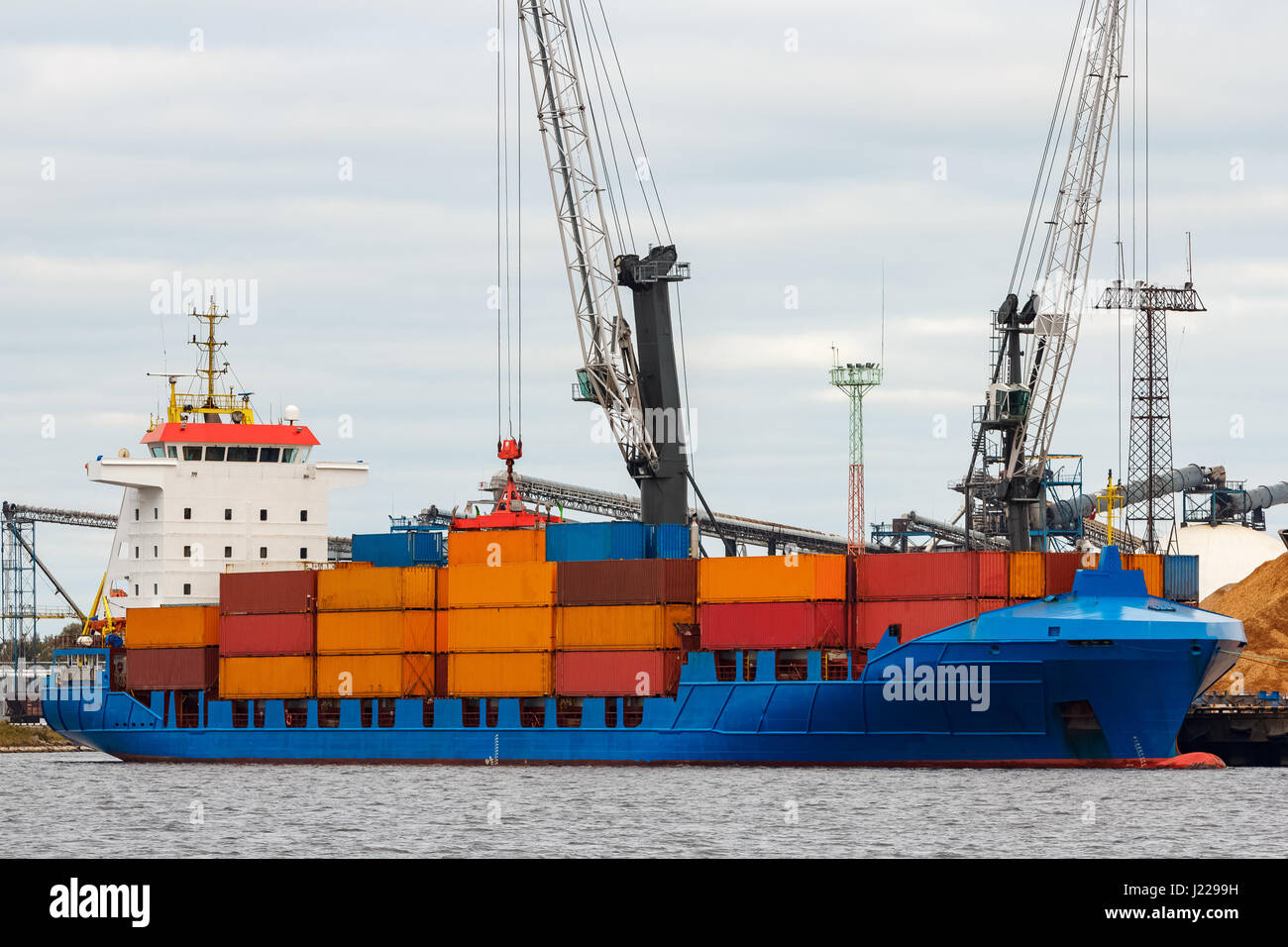 Blue container ship loading in cargo port of Europe Stock Photo - Alamy