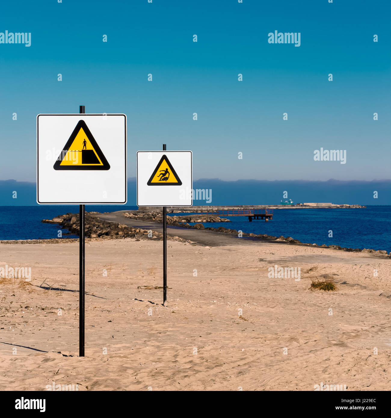 Yellow warning signs on summer beach, Riga Stock Photo - Alamy