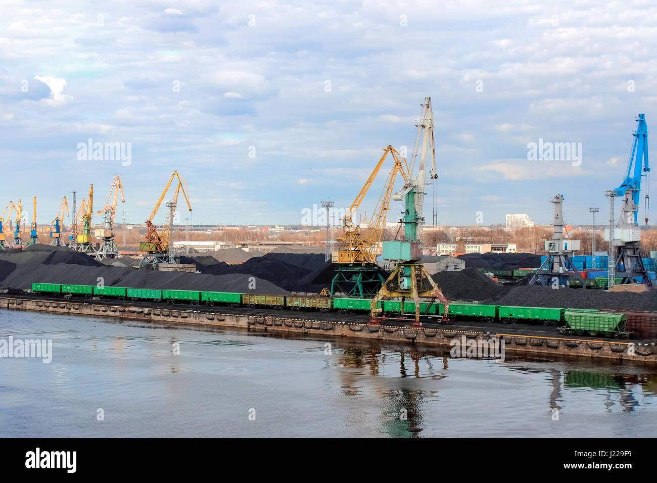 Baltic coal terminal with port cranes near the river. Riga cargo Stock ...