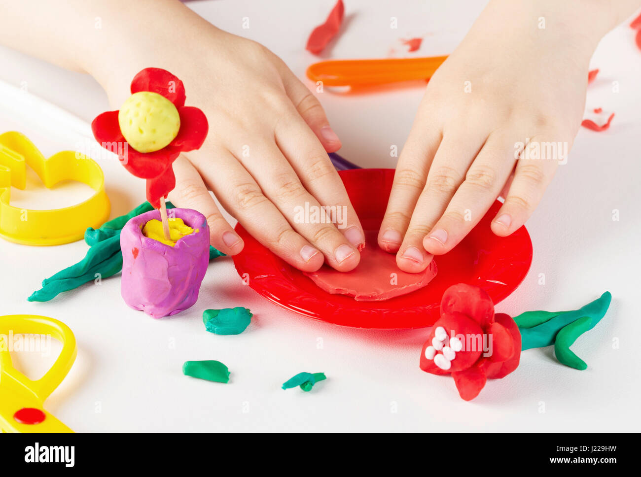 Child hands playing with colorful clay Stock Photo - Alamy