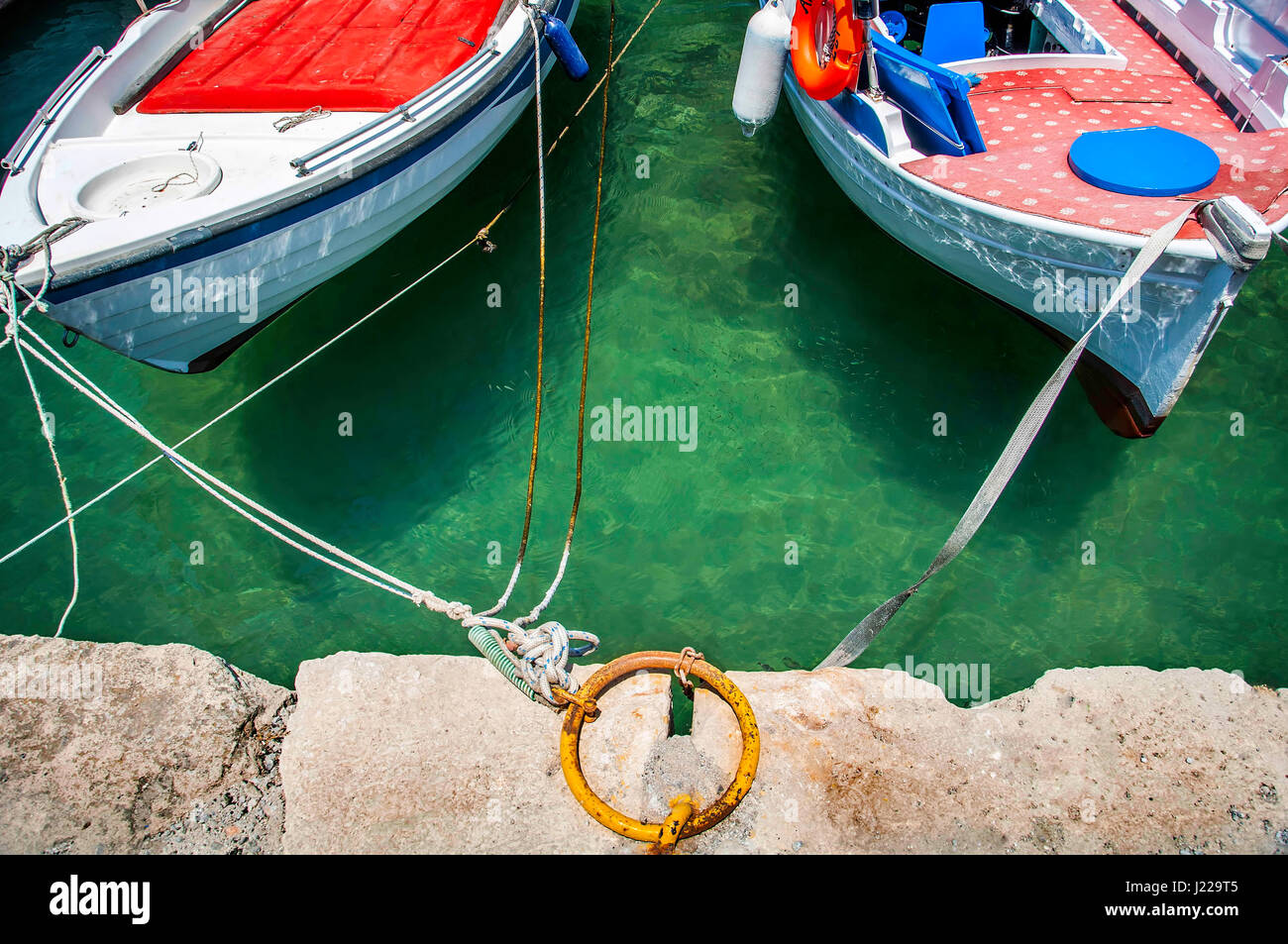 Two little boats are tied together Stock Photo - Alamy
