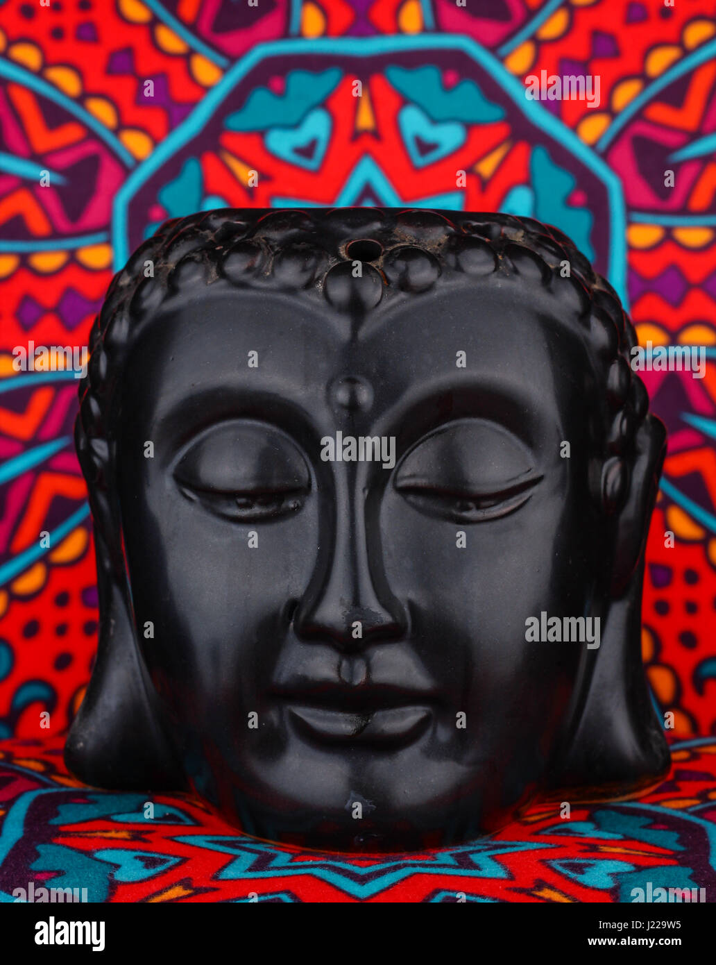 Buddha statue on a colorful background / featuring a wooden statue of ...