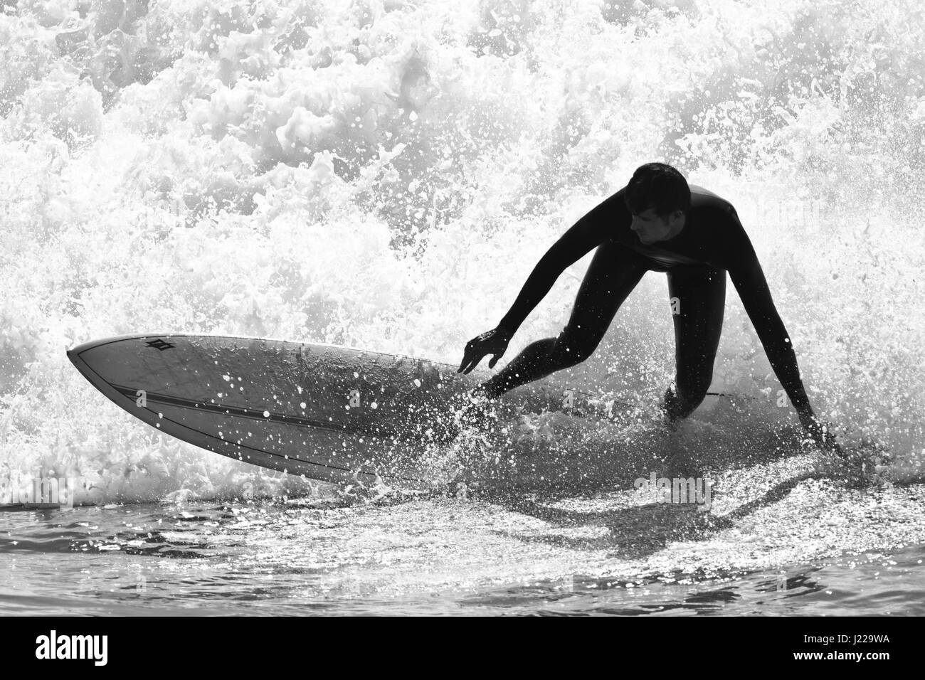 Surfer riding wave in Morocco Stock Photo - Alamy