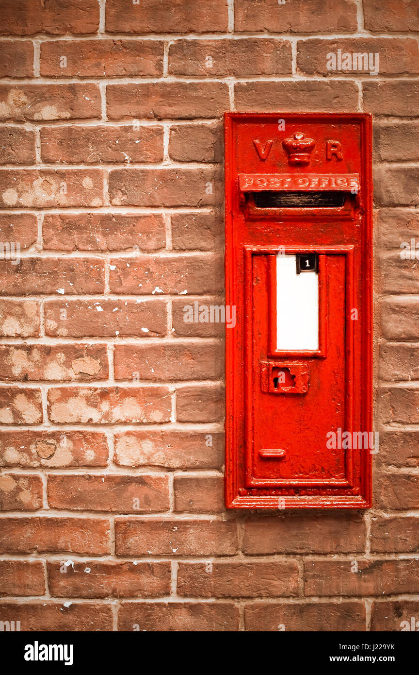 victorian mail box abstract against a brick wall with blank white space ...