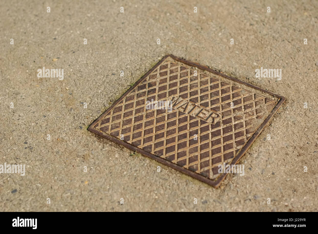 close-up of a water utility drain cover Stock Photo - Alamy