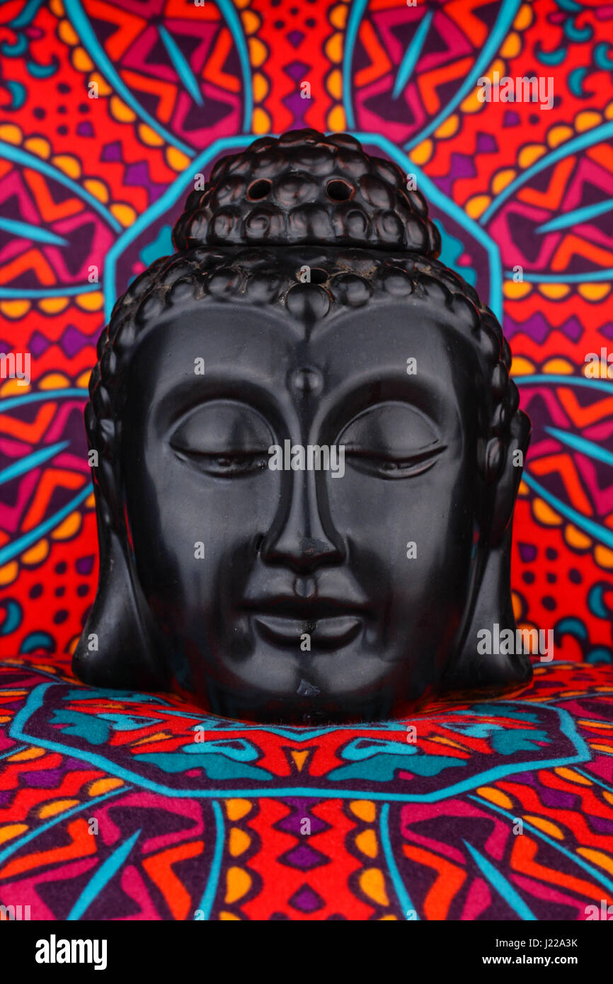 Buddha statue on a colorful background / featuring a wooden statue of ...