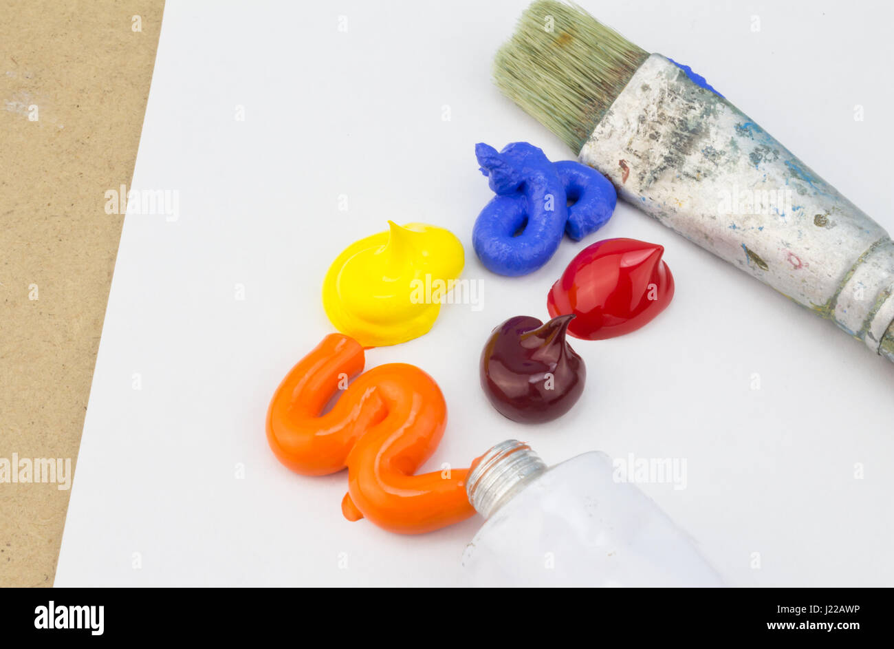 Artist oil colours squeezed out of tube with old art brush isolated on ...
