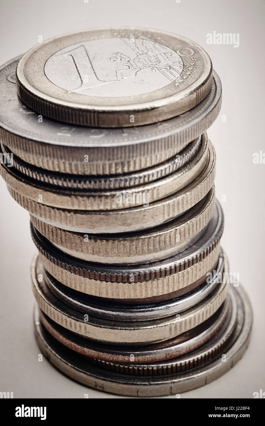 Different kinds of coins over a white background. Macro detail ...