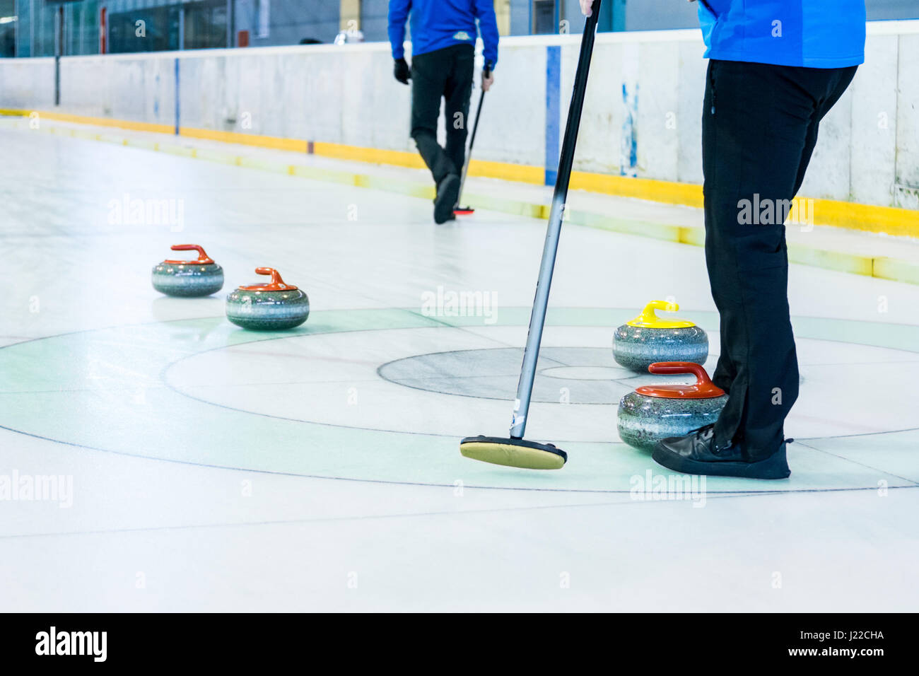 Playing a game of curling. Indoor sport played on ice Stock Photo - Alamy