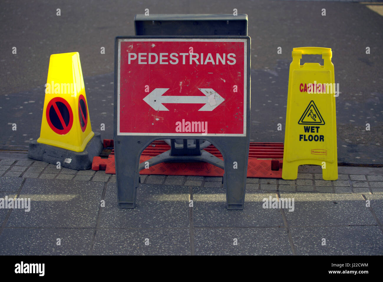pedestrians this way sign on road path with wet floors warning Stock ...