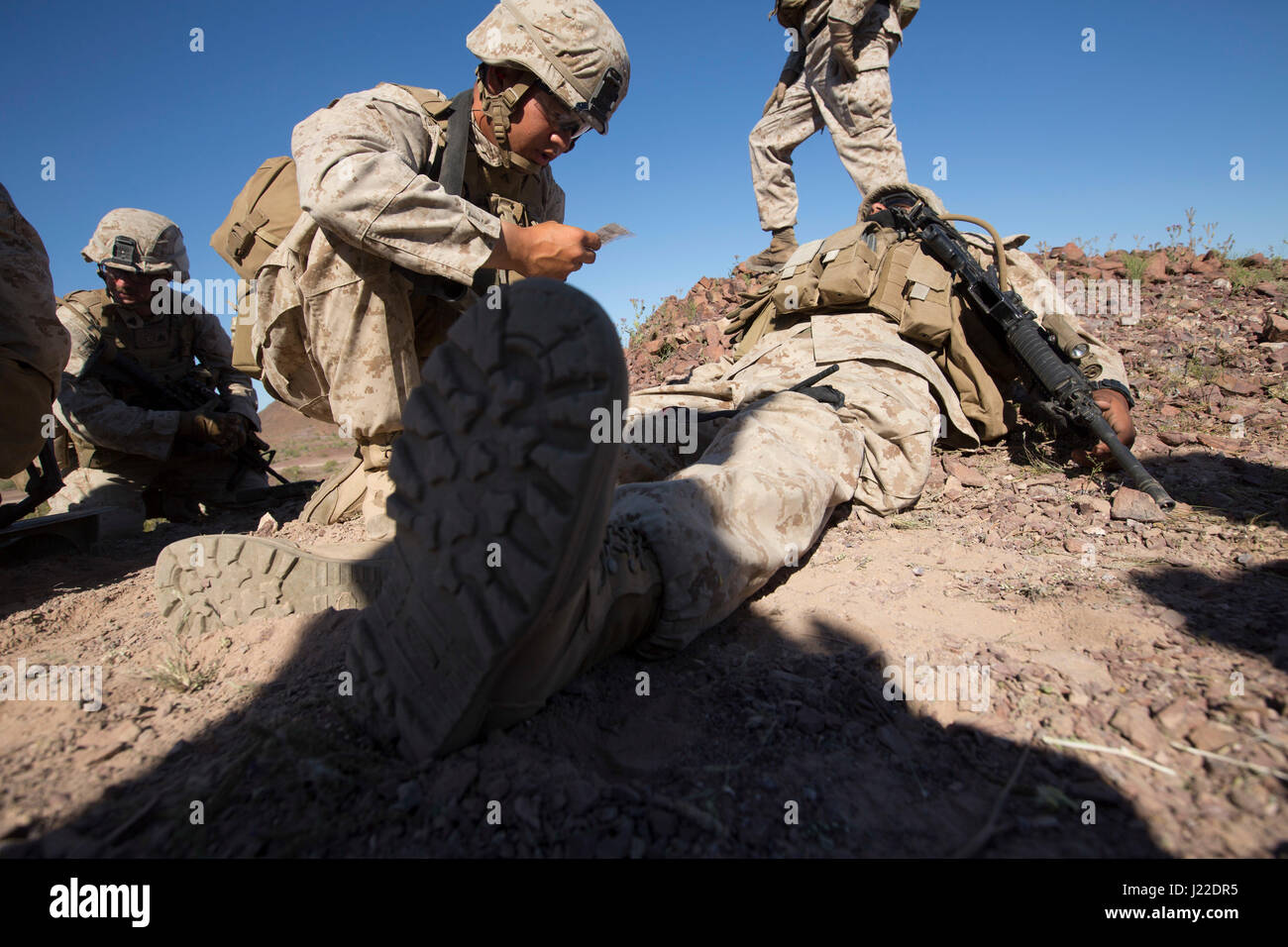 A Marine mortarman tends to a simulated casualty during platoon-level ...