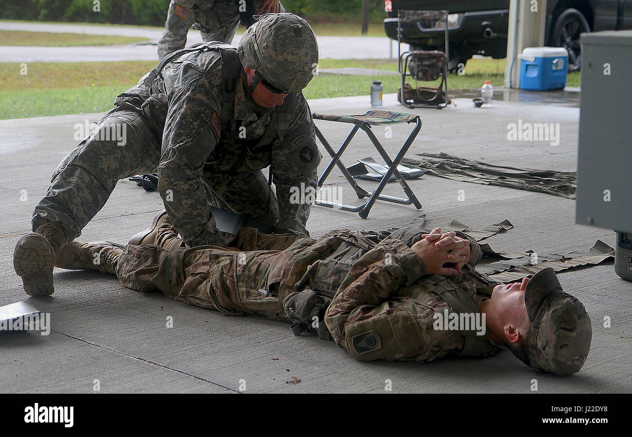 A U.S. Army National Guard Soldier treats simulated wounds of a Soldier ...